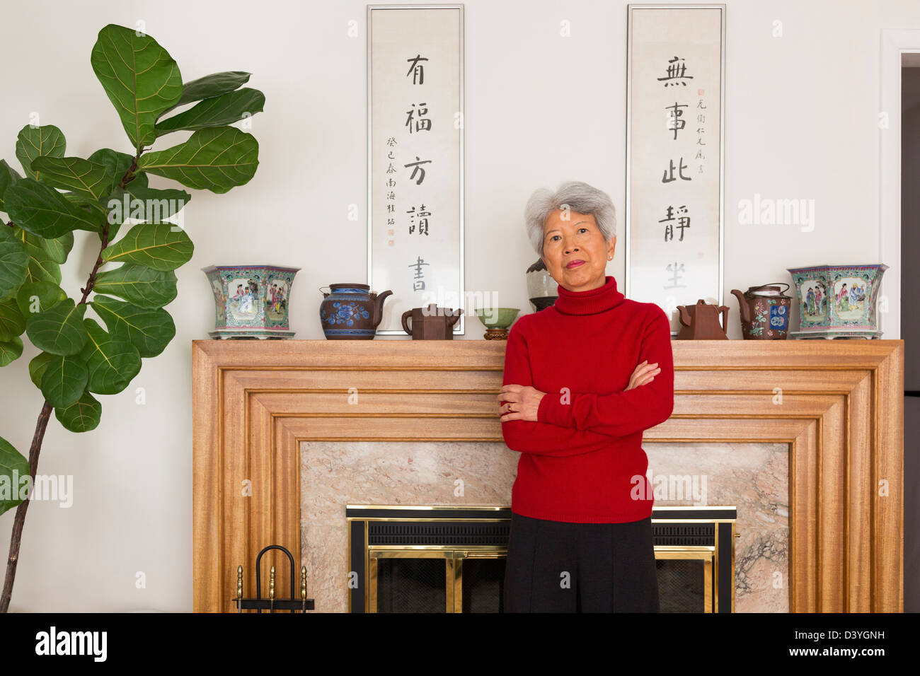 Chinese woman standing at fireplace Stock Photo - Alamy
