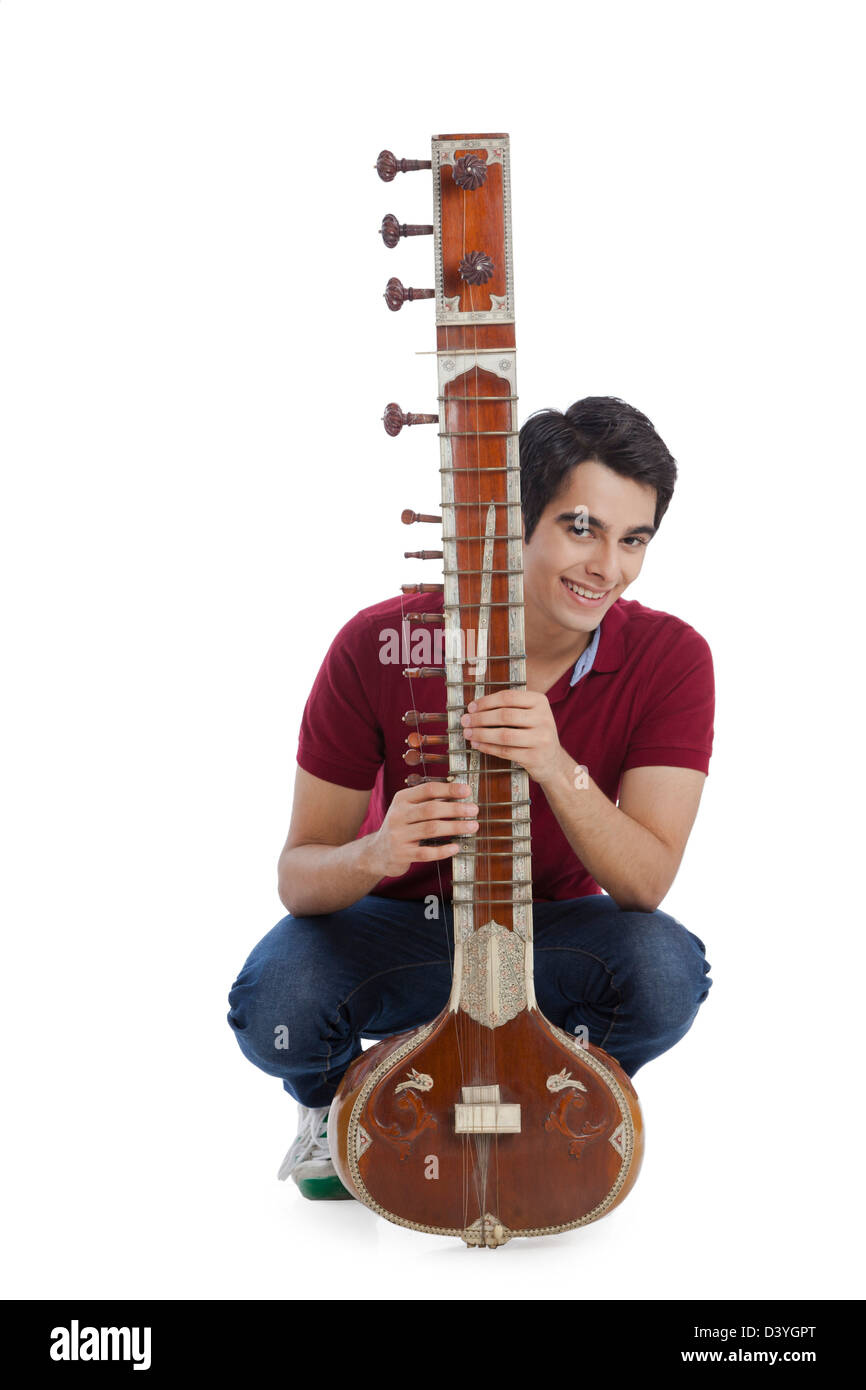 Portrait of a man playing a sitar and smiling Stock Photo - Alamy