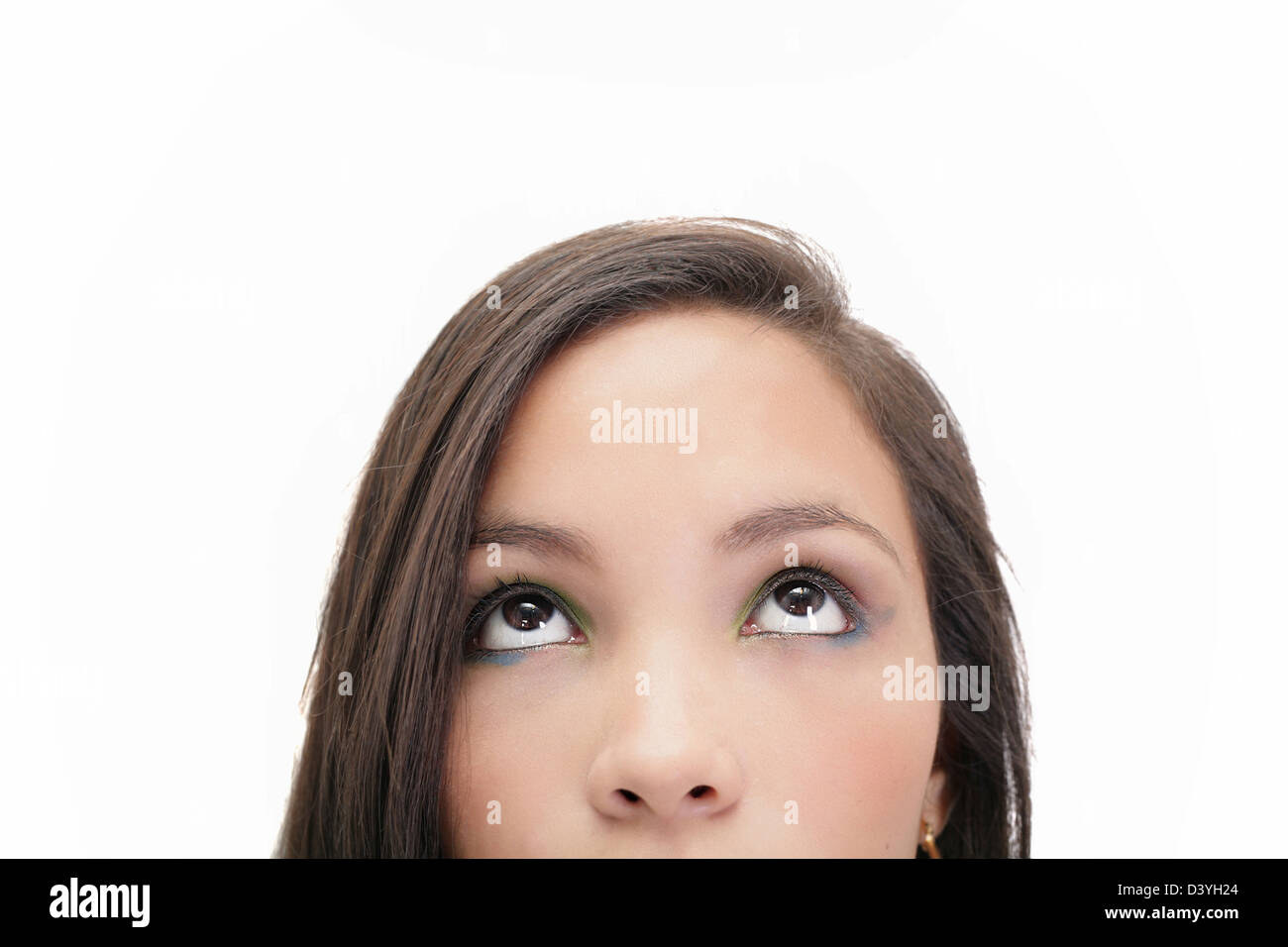 Closeup portrait of a beautiful young woman looking up, isolated on ...