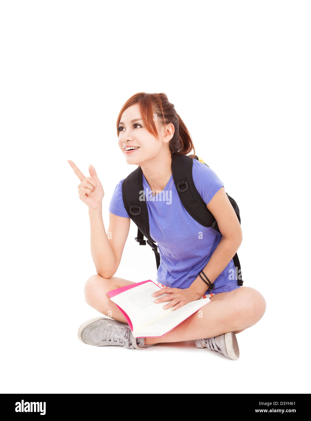 student girl reading book and pointing at something Stock Photo - Alamy
