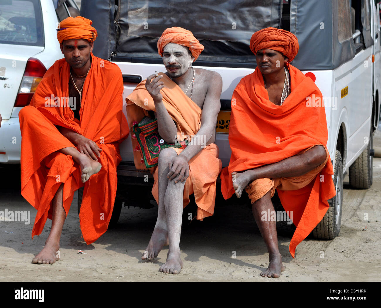 A group of Sadhus, Hindu holy men, rest near holy Ganges river during ...