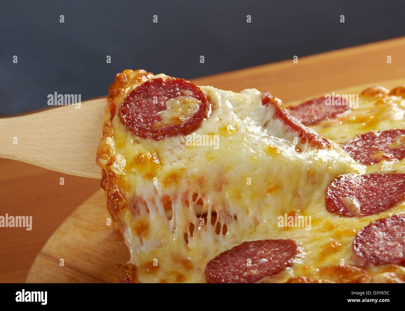 homemade pizza Pepperoni .taking slice of pizza,melted cheese dripping ...