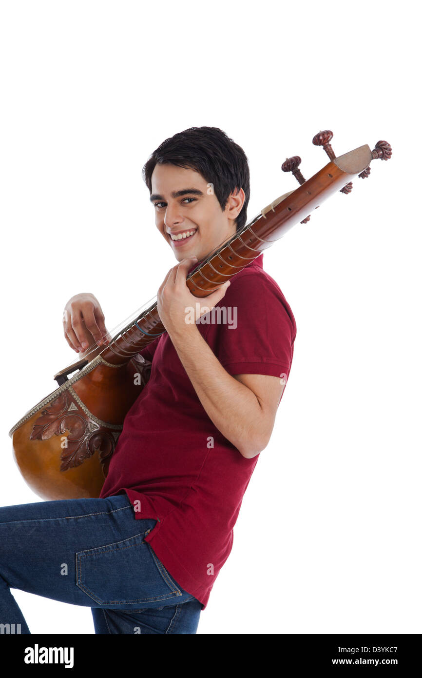 Man playing a sitar and smiling Stock Photo - Alamy