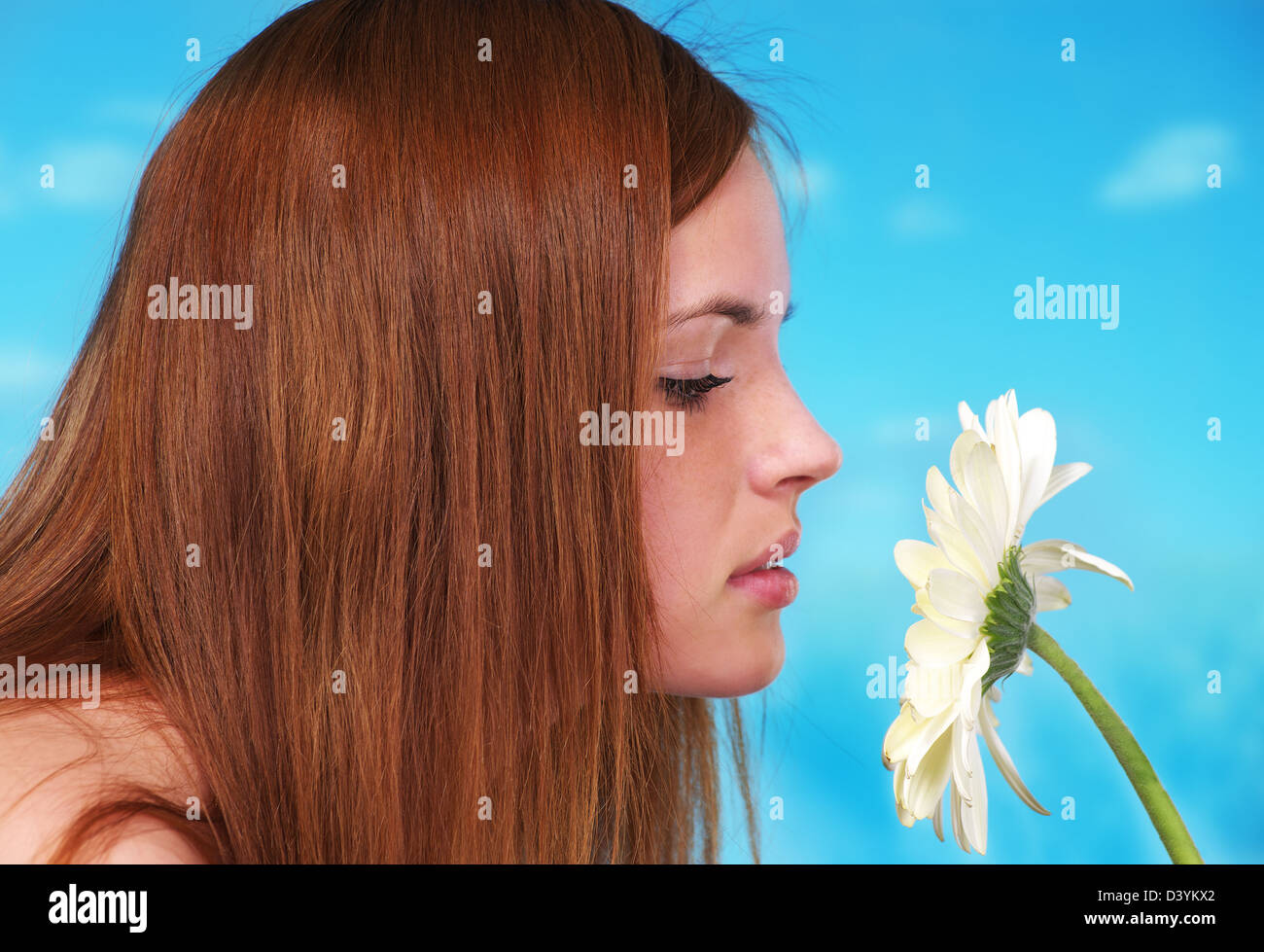 Closeup portrait of beautiful young female smelling a flower Stock ...