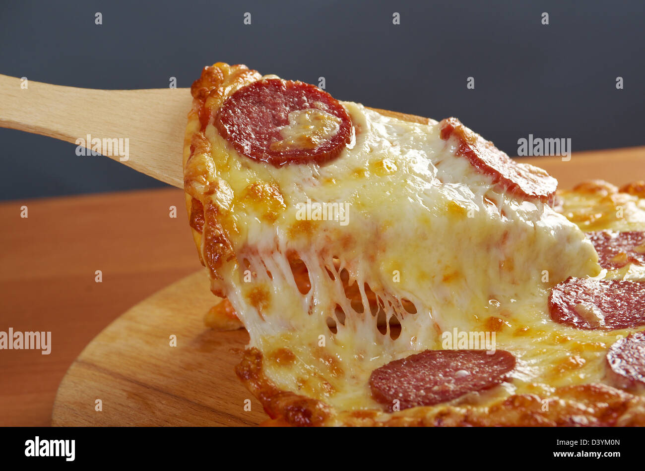 homemade pizza Pepperoni .taking slice of pizza,melted cheese dripping ...