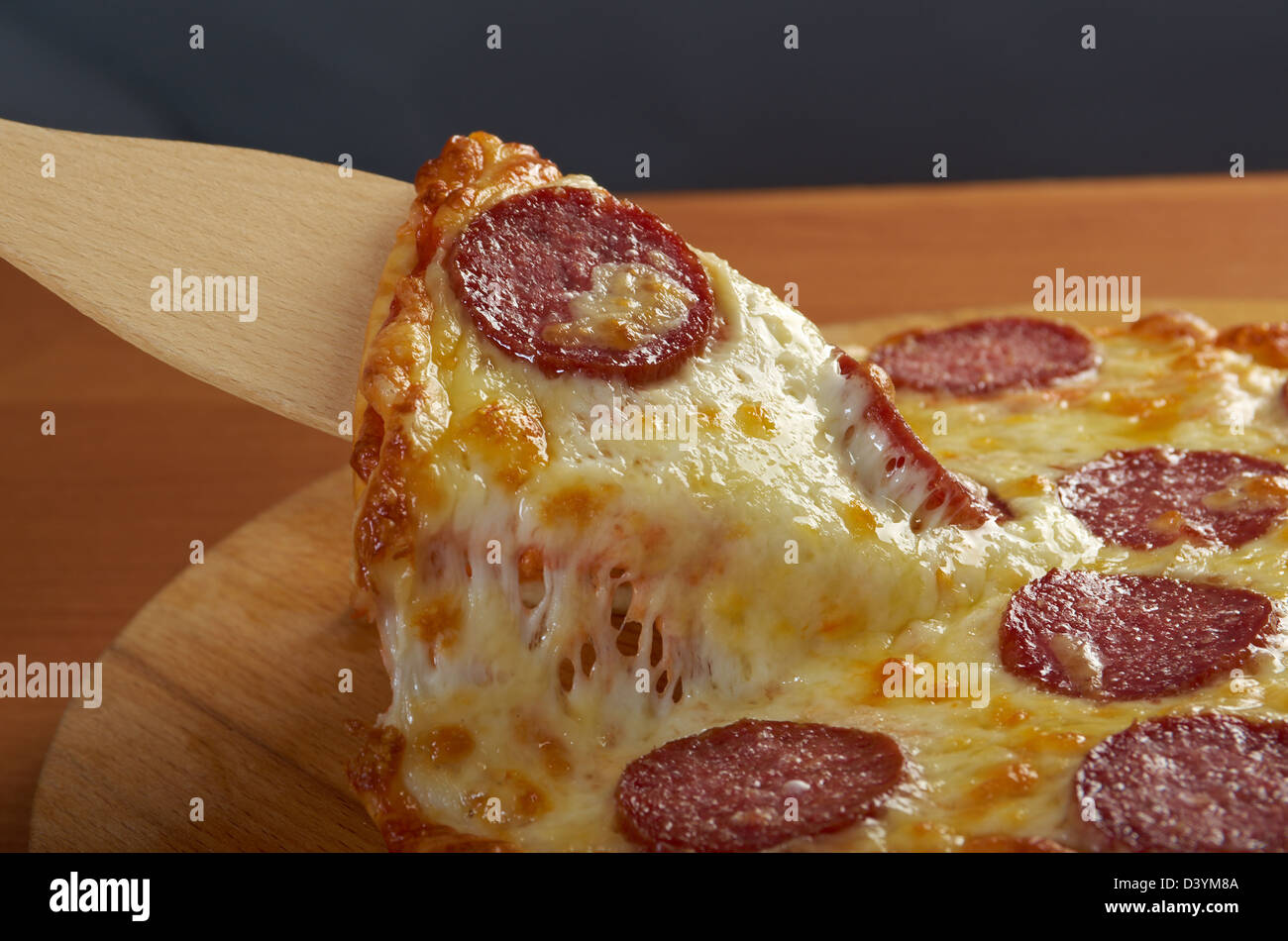 homemade pizza Pepperoni .taking slice of pizza,melted cheese dripping ...