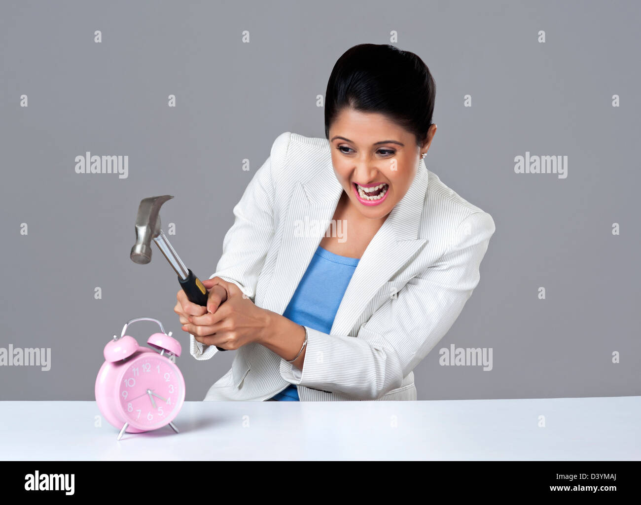 Businesswoman smashing alarm clock with hammer Stock Photo - Alamy Businesswoman smashing alarm clock with hammer Stock Photo - Alamy