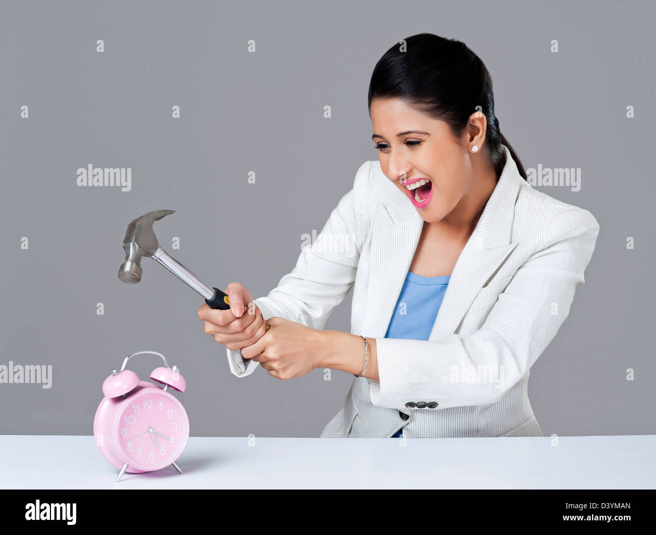 Businesswoman smashing alarm clock with hammer Stock Photo - Alamy Businesswoman smashing alarm clock with hammer Stock Photo - Alamy