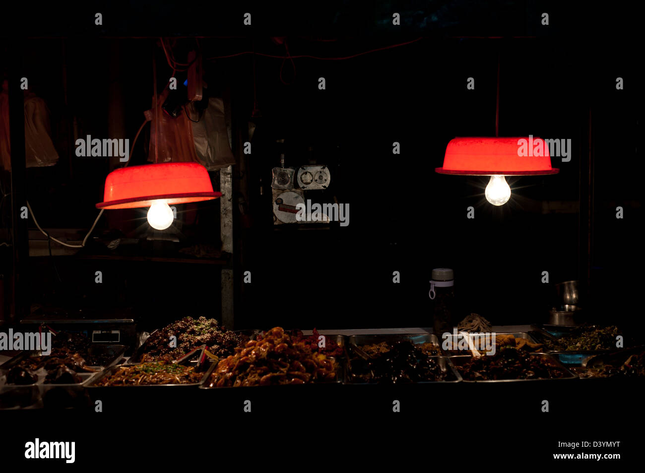 Traditional red lamps light up a food stall at a Shanghai outdoor food ...
