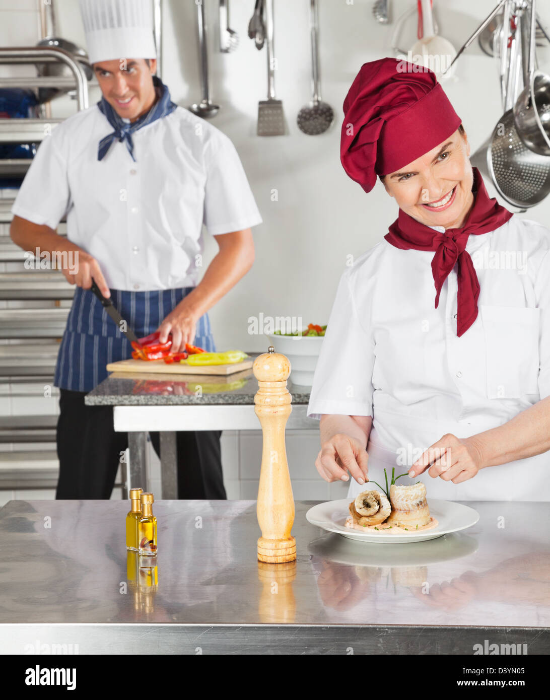 Female Chef Garnishing Dish In Kitchen Stock Photo - Alamy