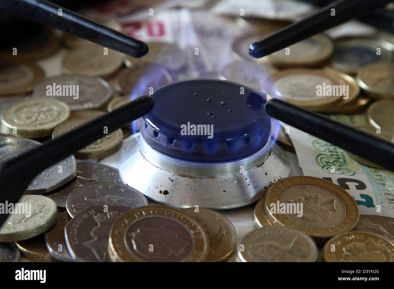 Lots of coin around a gas burner on a cooker. The owner of British Gas ...