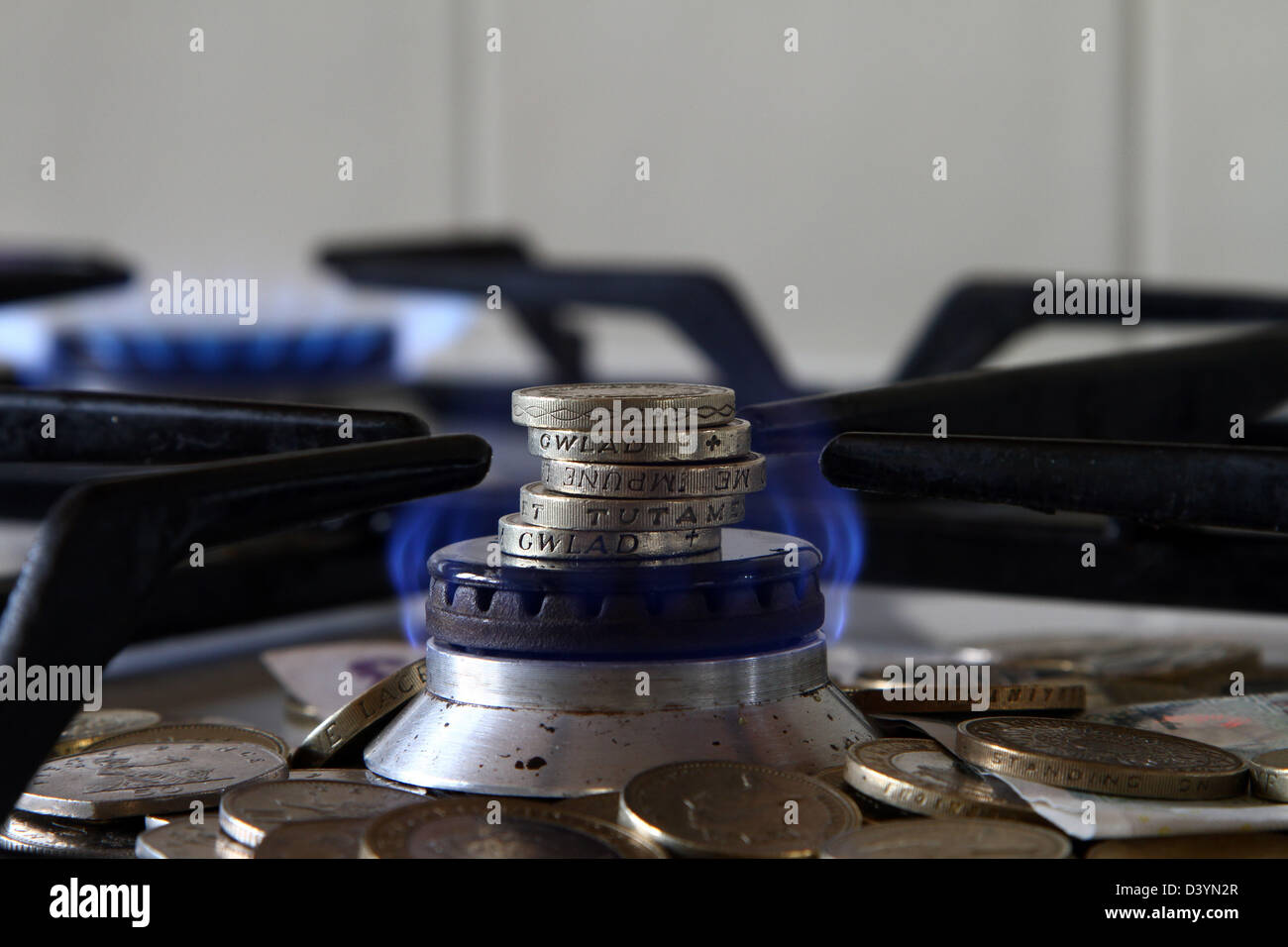 Lots of coin around a gas burner on a cooker. The owner of British Gas ...