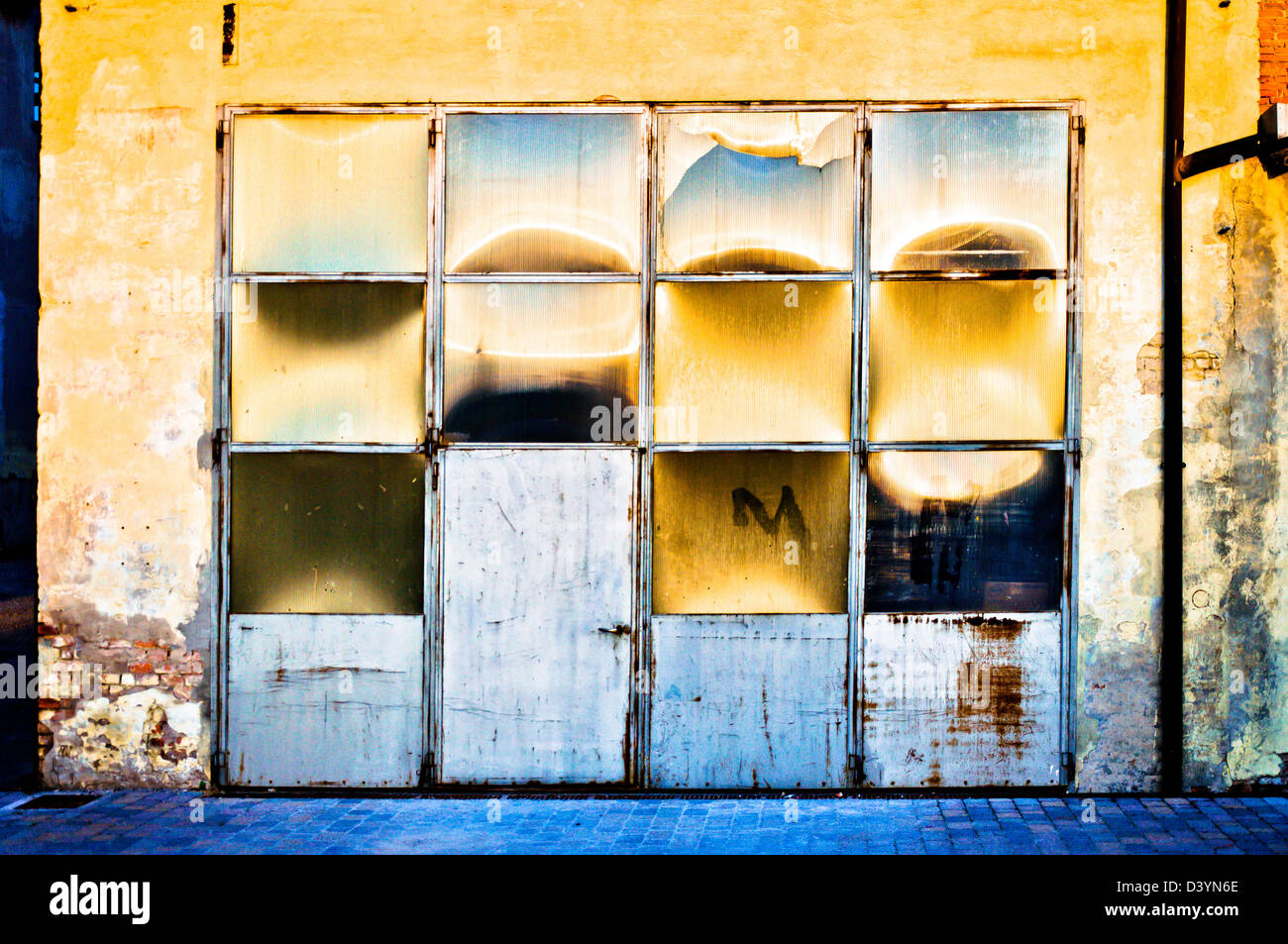 Old metal and glass warehouse door with sun reflections Stock Photo - Alamy
