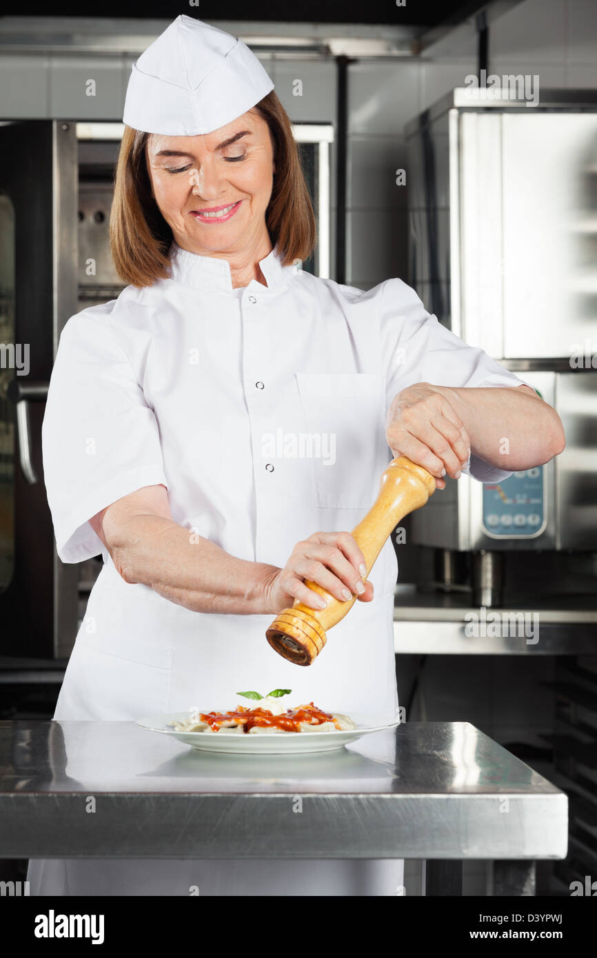 Chef Seasoning Dish With Peppermill Stock Photo - Alamy