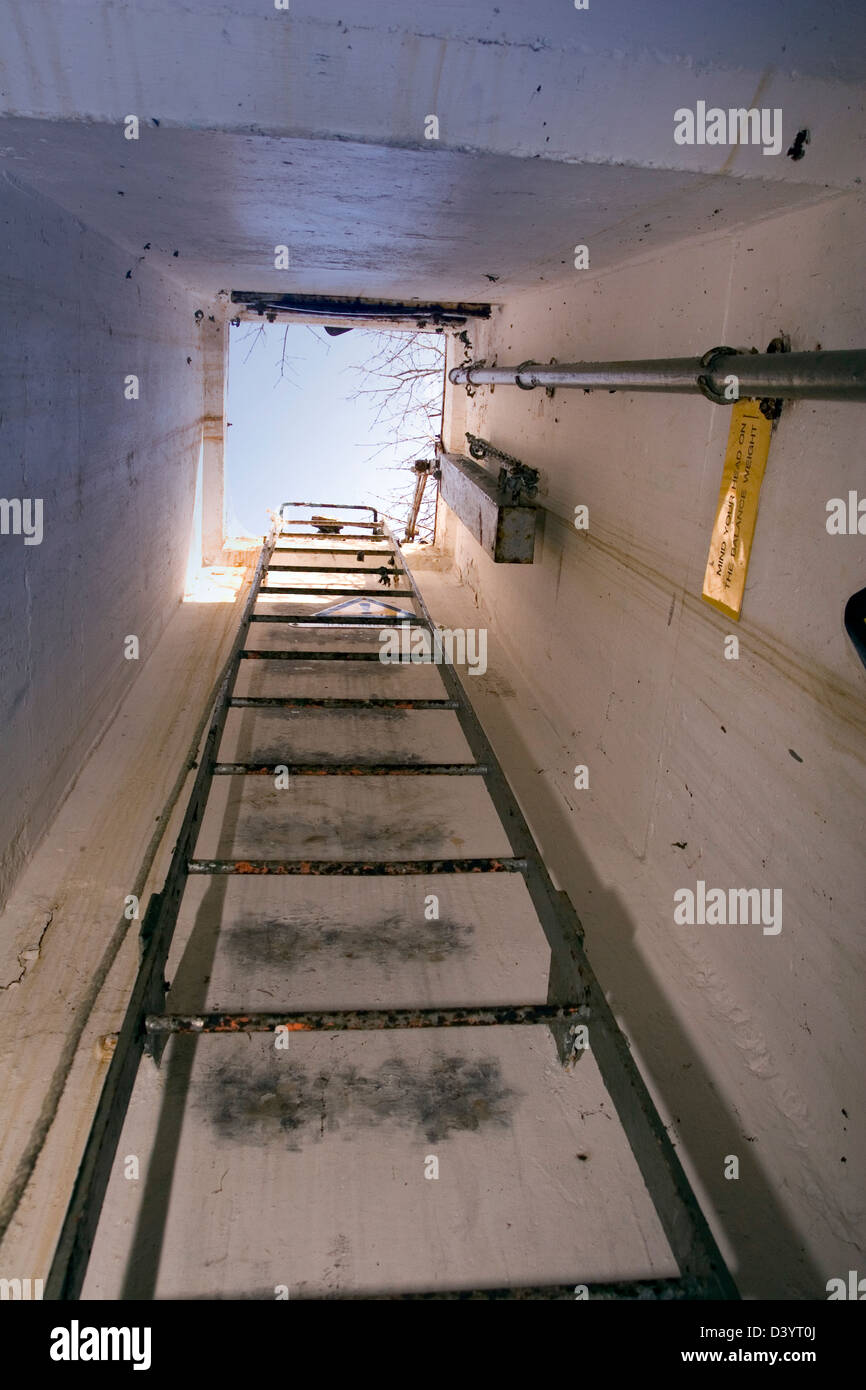 View of sky through opening hatch to underground bunker showing ladder ...