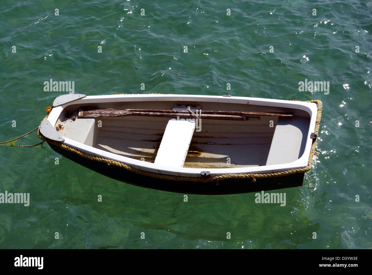 Small rowing boat moored in a harbour Stock Photo - Alamy