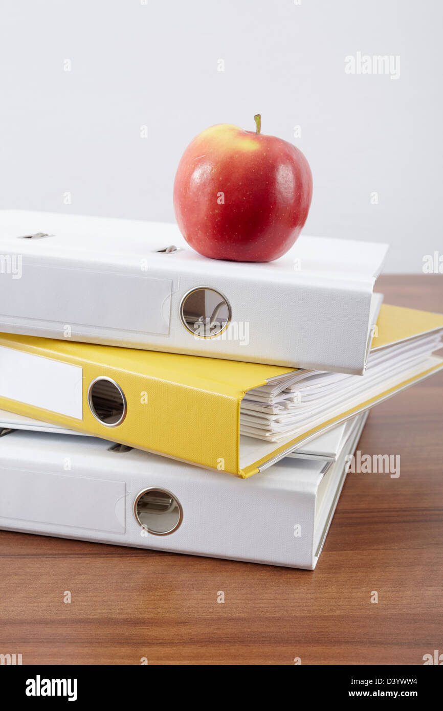 Stack of Binders and Apple Stock Photo - Alamy
