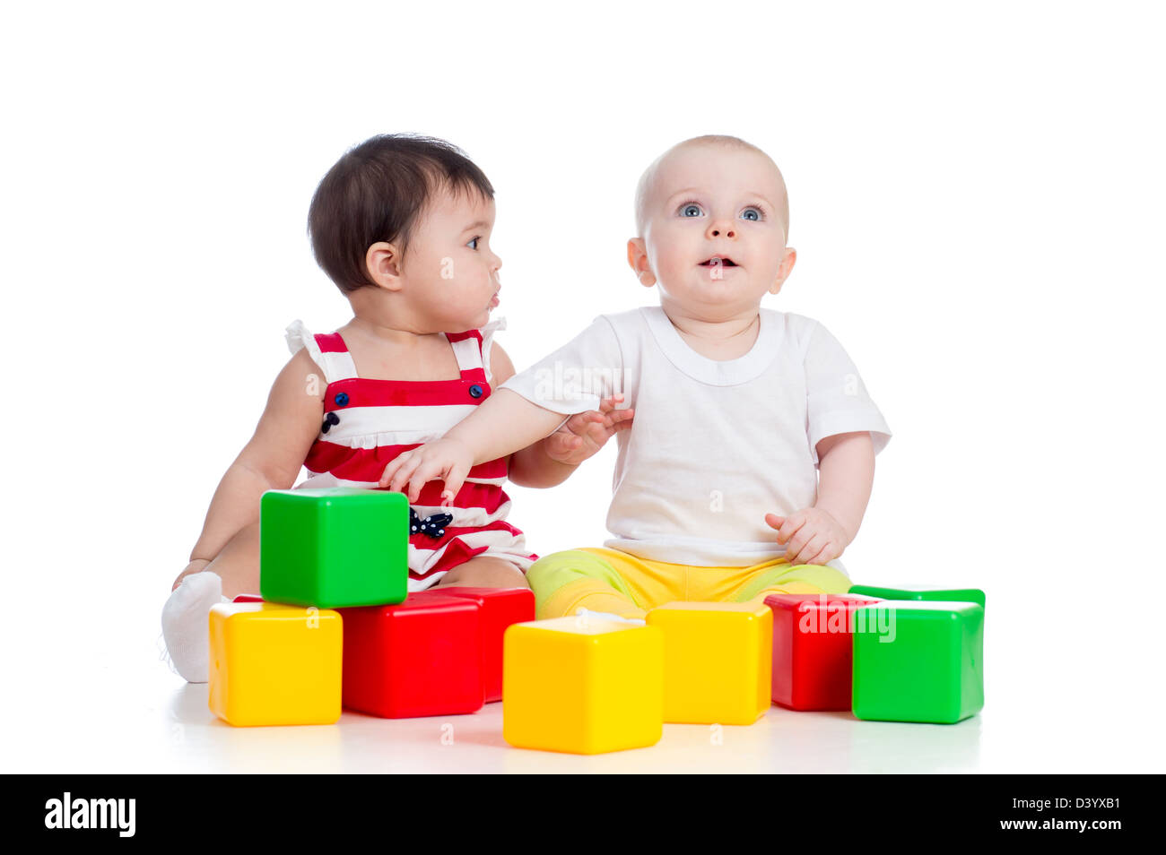 two babies girls playing together with color toys Stock Photo - Alamy