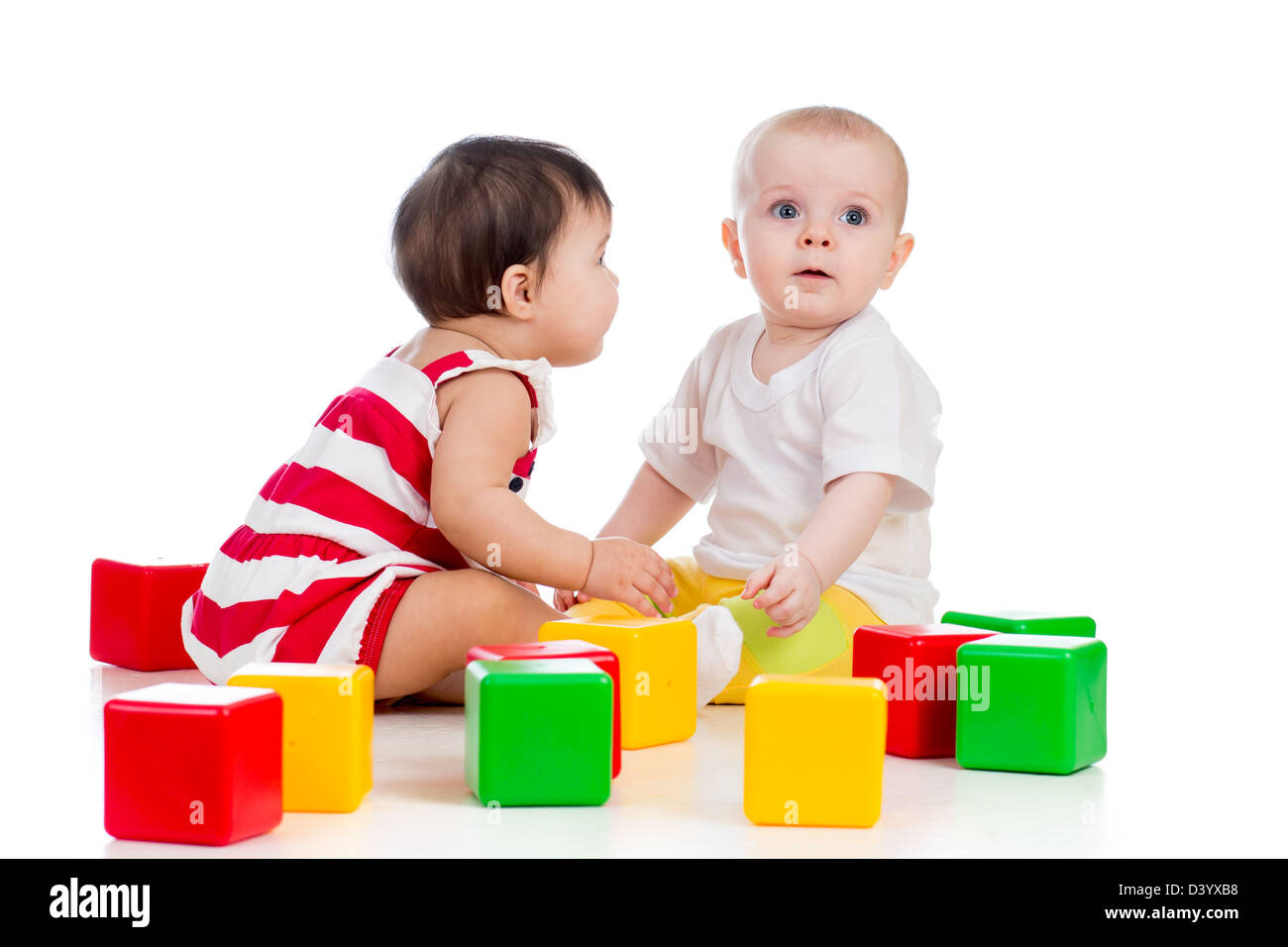 two babies girls playing together with color toys Stock Photo - Alamy