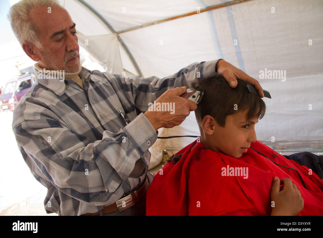 Azaz, Syria. 27th February 2013. A boy gets a haircut at the Azaz ...