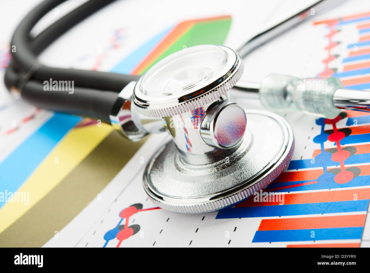 Stethoscope on a statistics graphic with graphs Stock Photo - Alamy