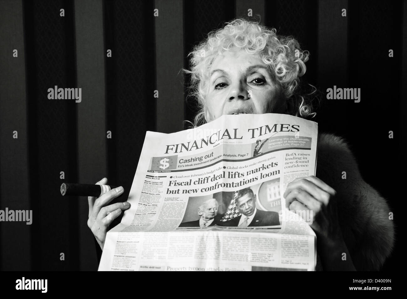 Senior successful woman holding a cigar biting the financial times ...