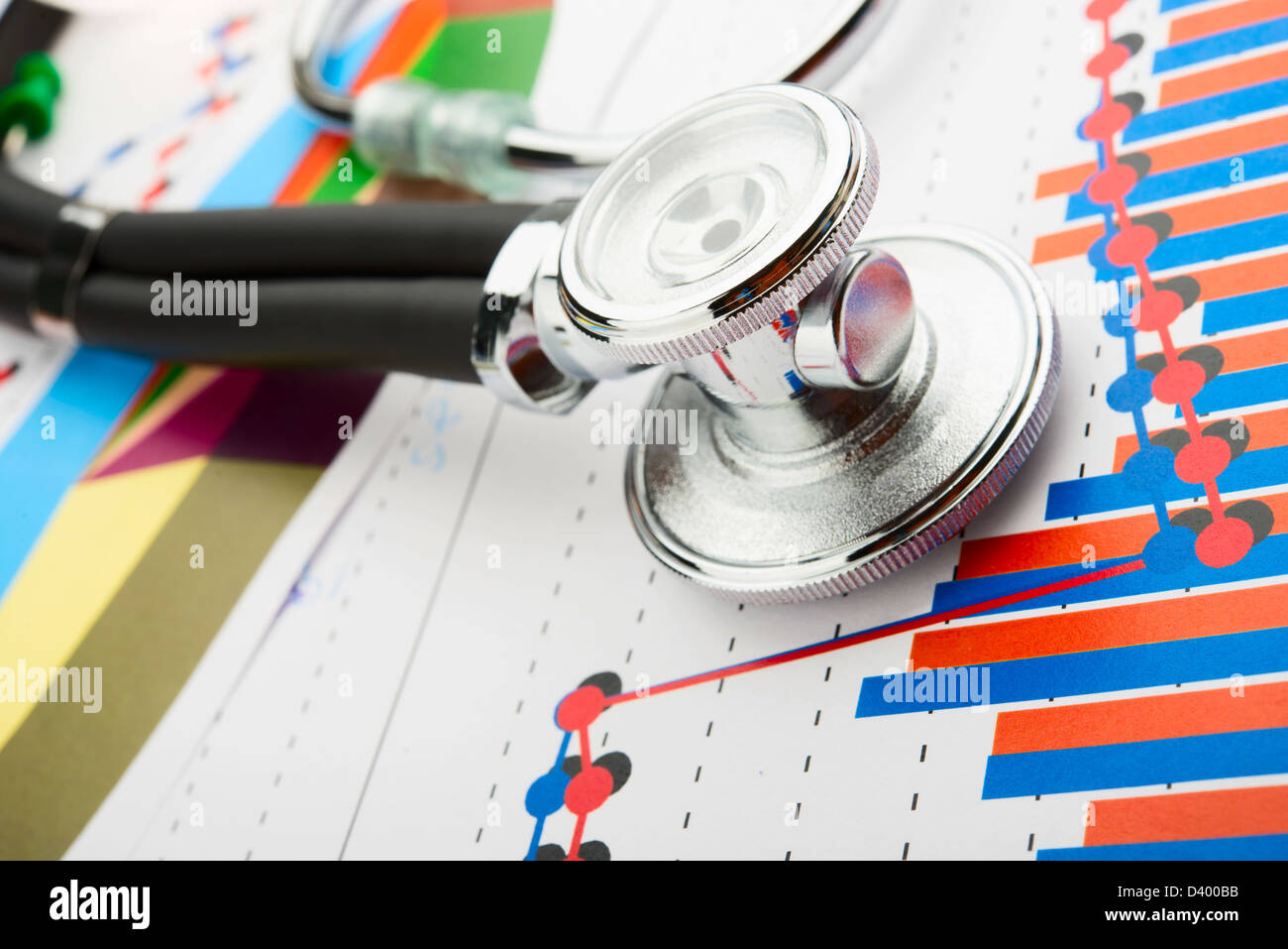 Stethoscope on a statistics graphic with graphs Stock Photo - Alamy