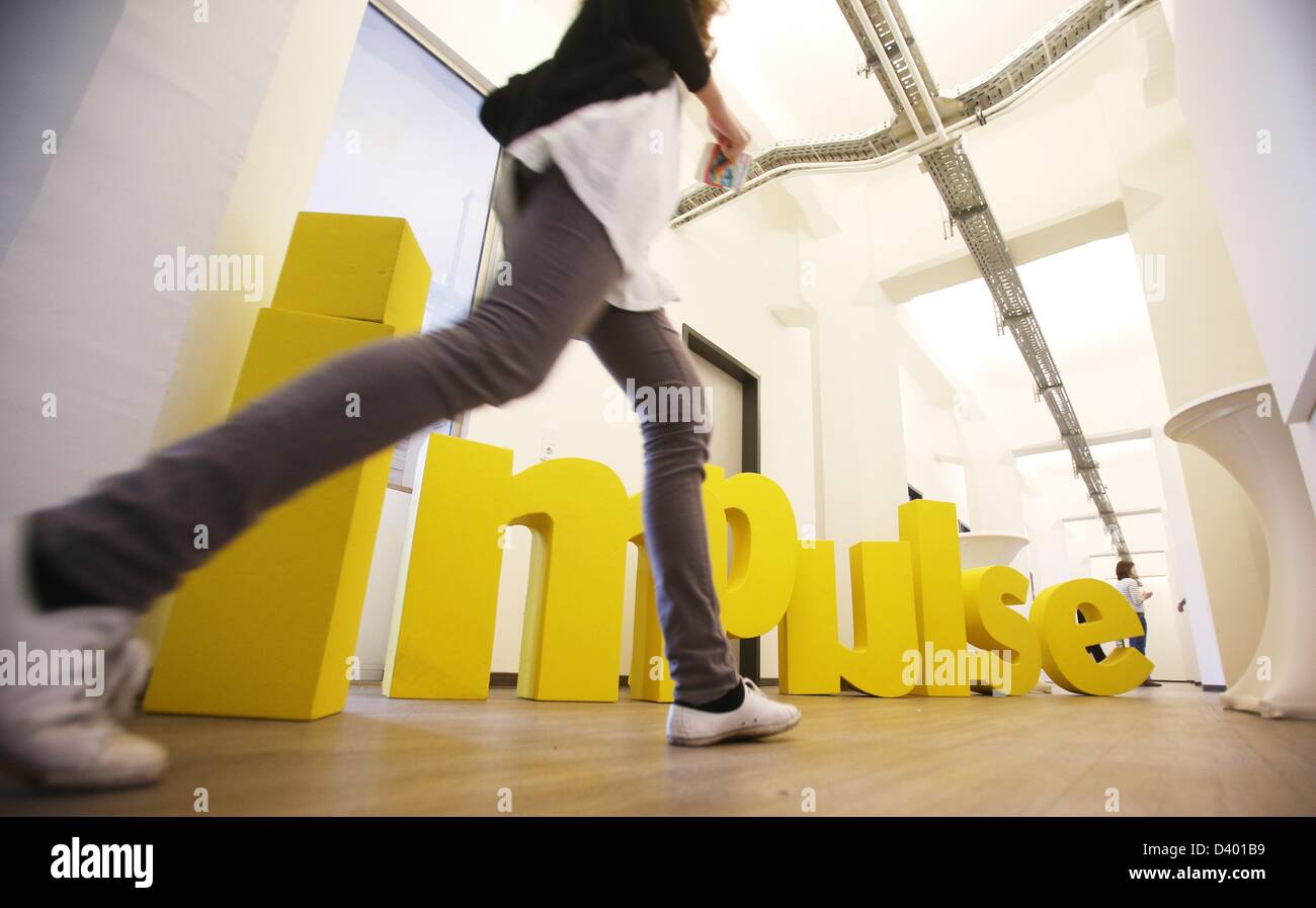 An employee of business magazine 'Impulse' walks past a 3D lettering of ...