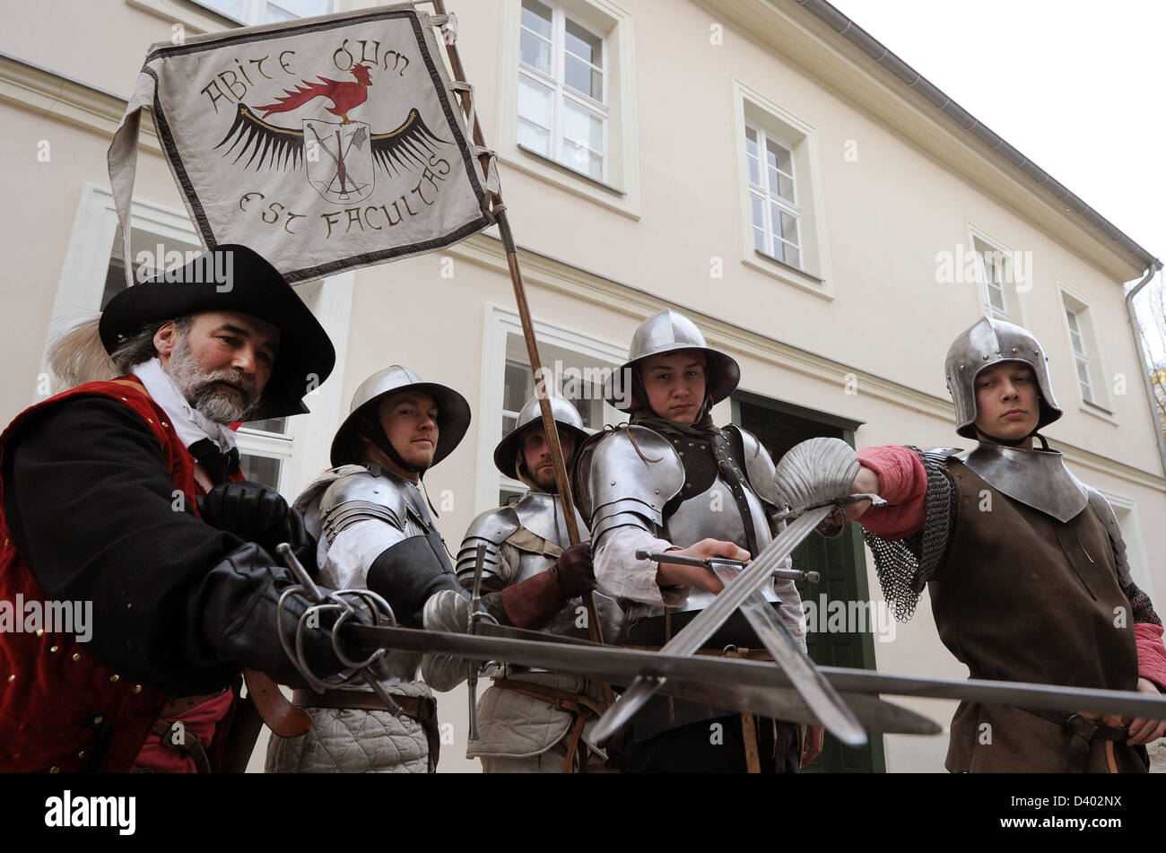 'The Brigands' cross their sword blades in front of the 'Headsman's ...