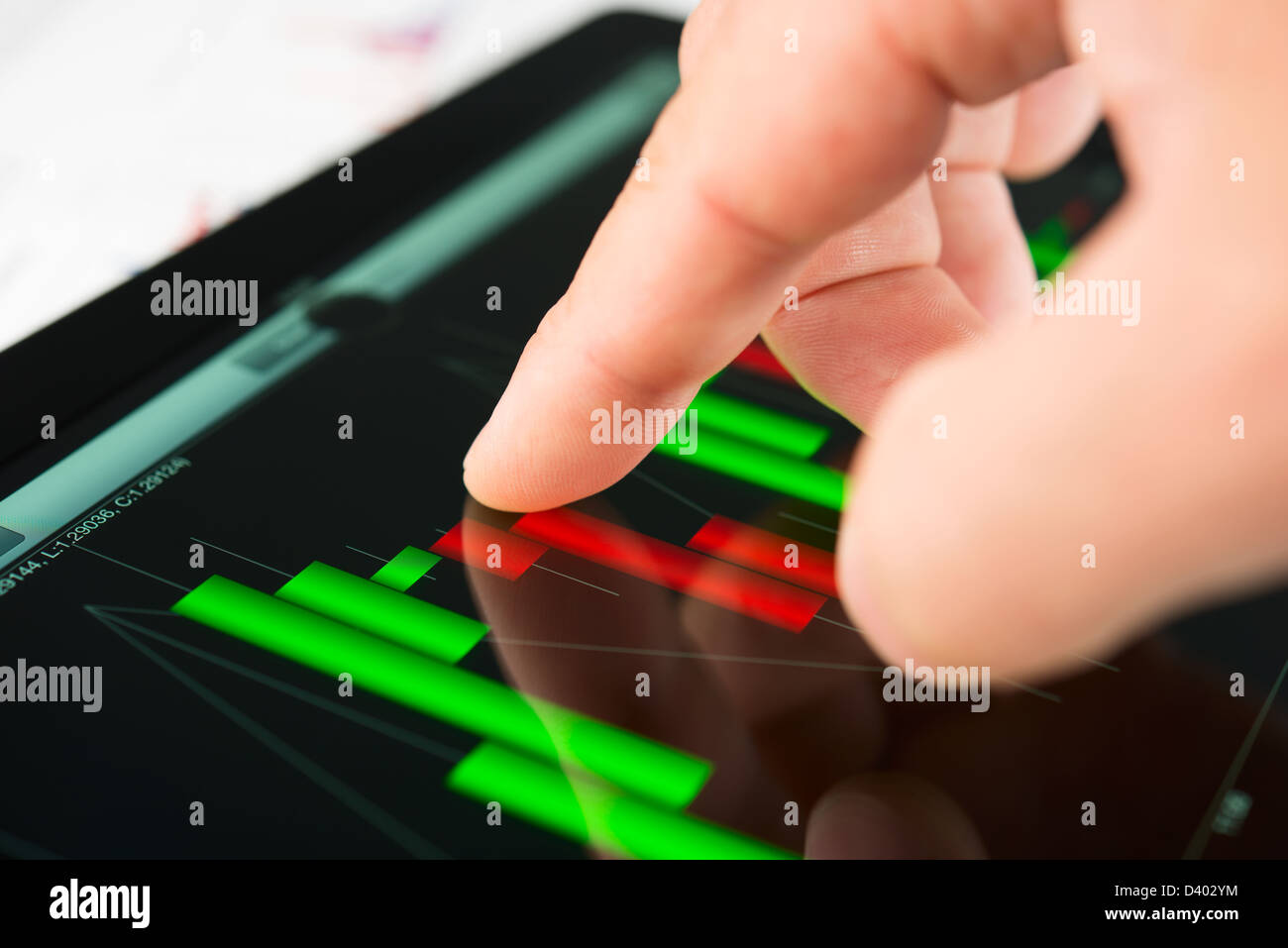 Businessman hand touching screen of tablet pc with market graph Stock ...