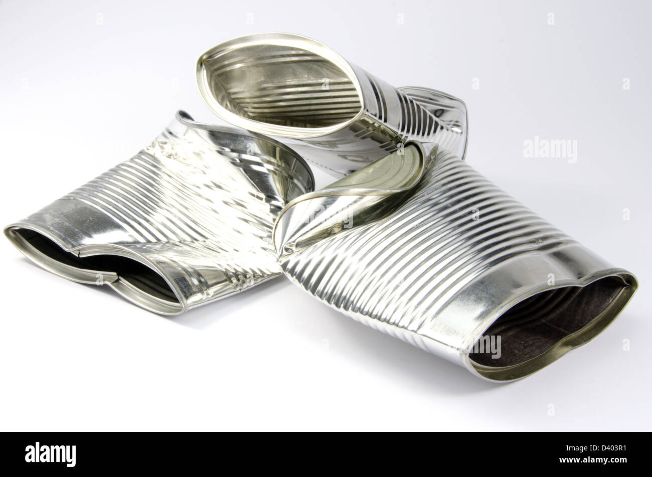 Three tin cans crushed on white background Stock Photo - Alamy