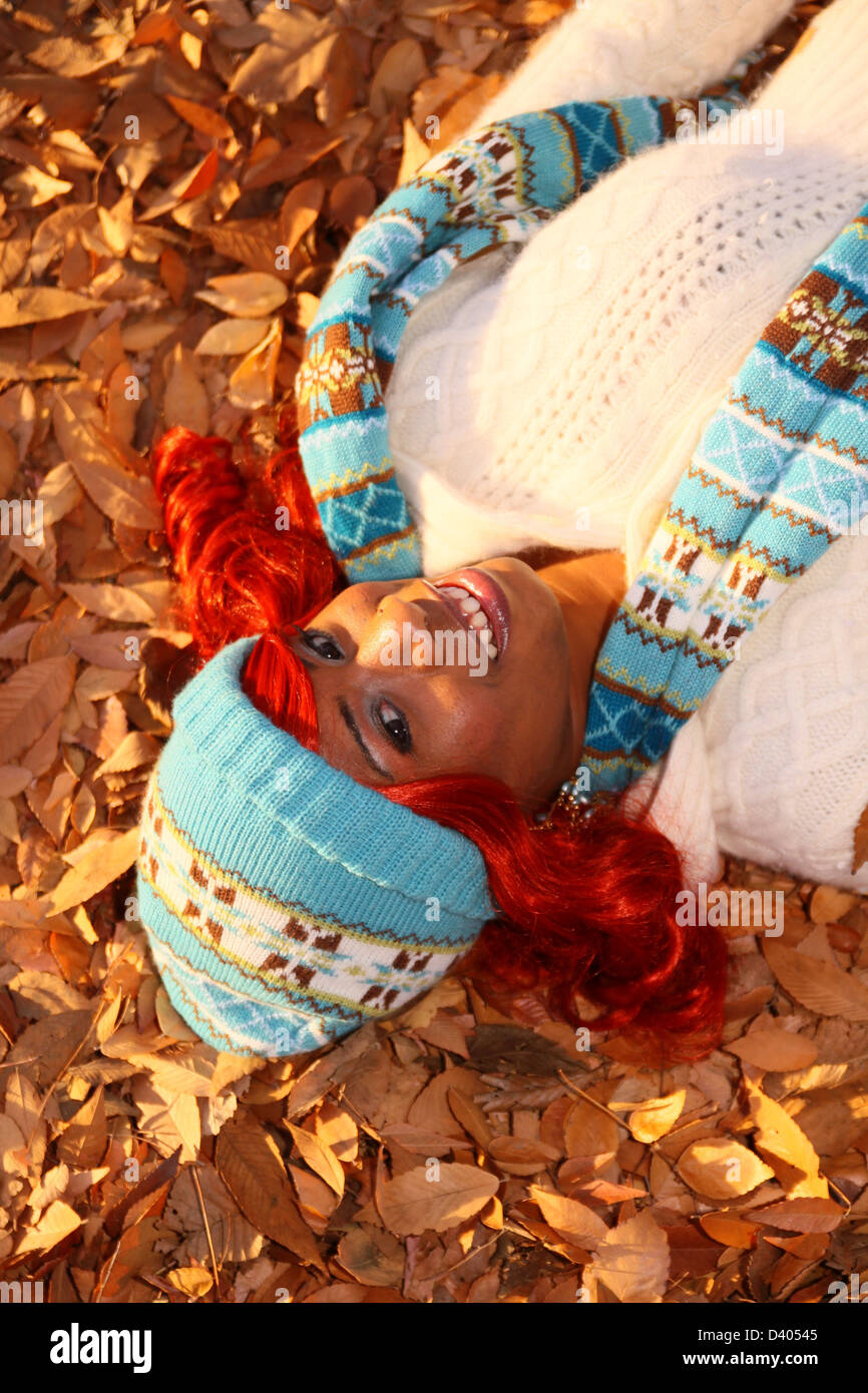 a young lady laying in the autumn leaves Stock Photo - Alamy