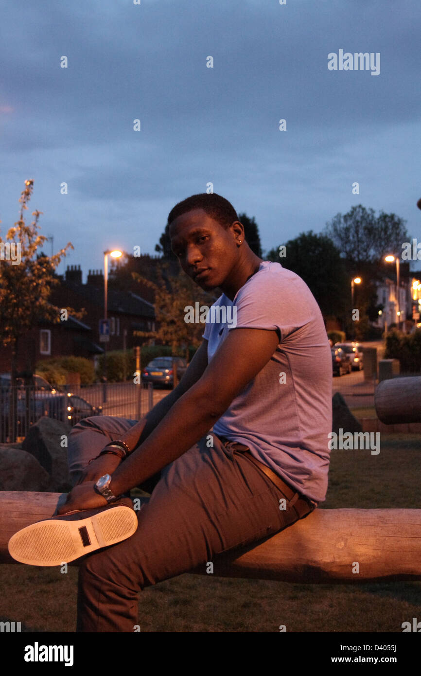 Black man sitting on log hi-res stock photography and images - Alamy