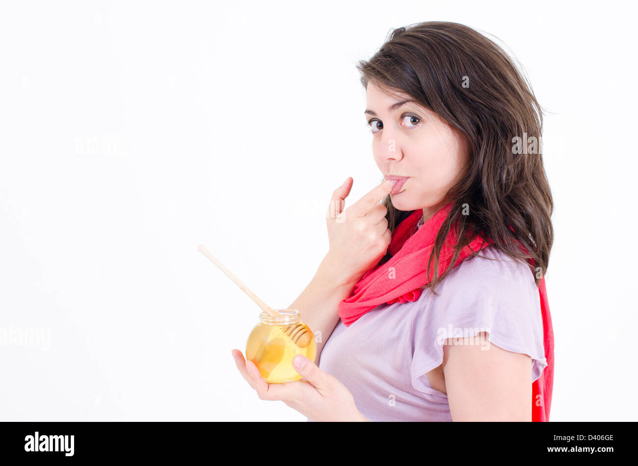 A cute girl tasting honey bee Stock Photo - Alamy