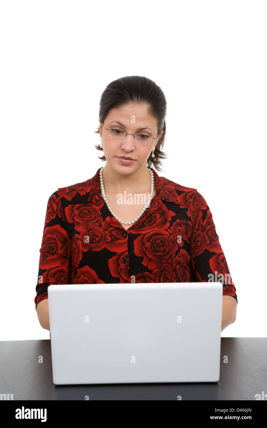 woman with glasses working on laptop computer against a white ...