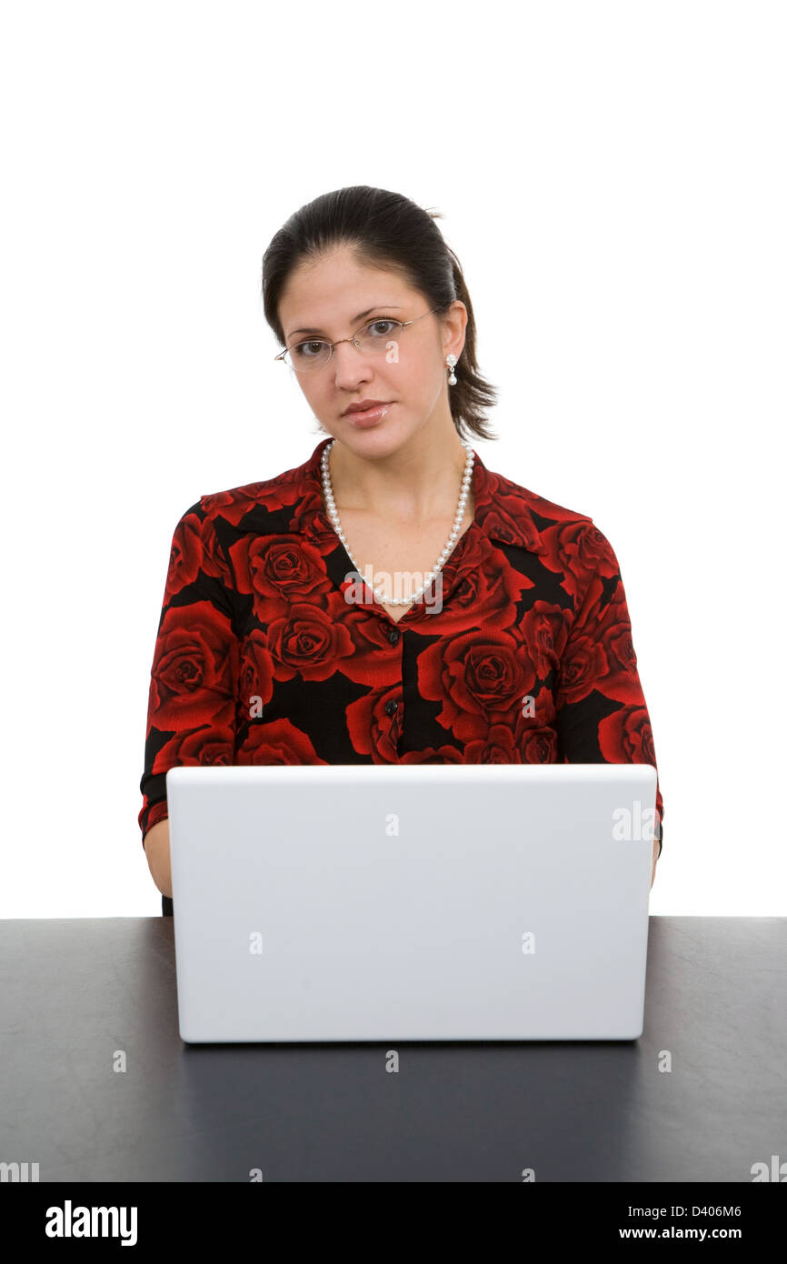 woman with glasses working on laptop computer against a white ...