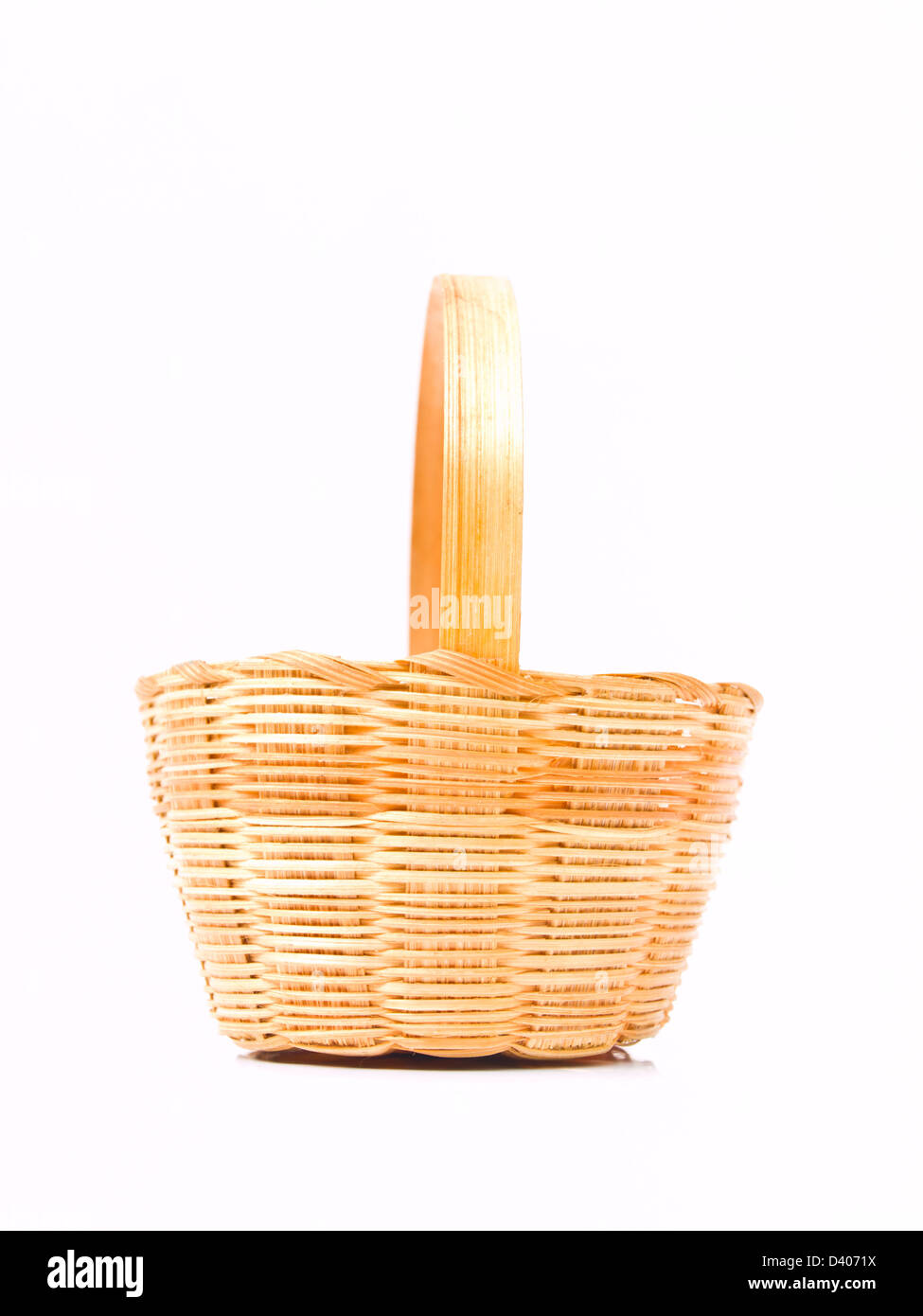A yellow wicker basket isolated on white background Stock Photo - Alamy