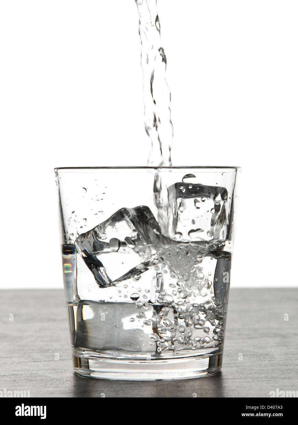 Glass of water over ice cubes with white background Stock Photo - Alamy