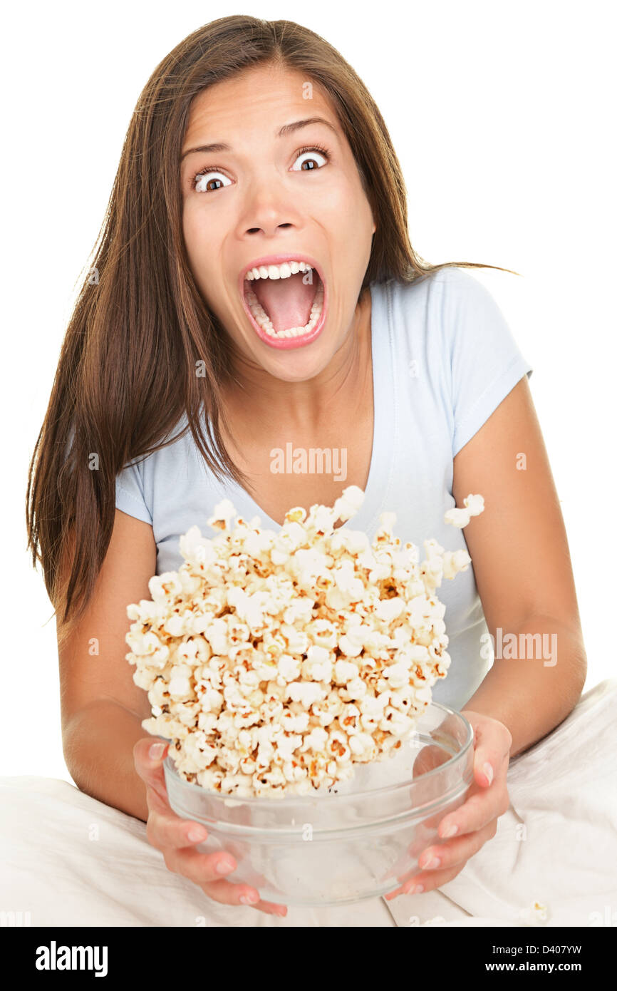 Portrait of scared young mixed race woman with popcorn spilling out of ...