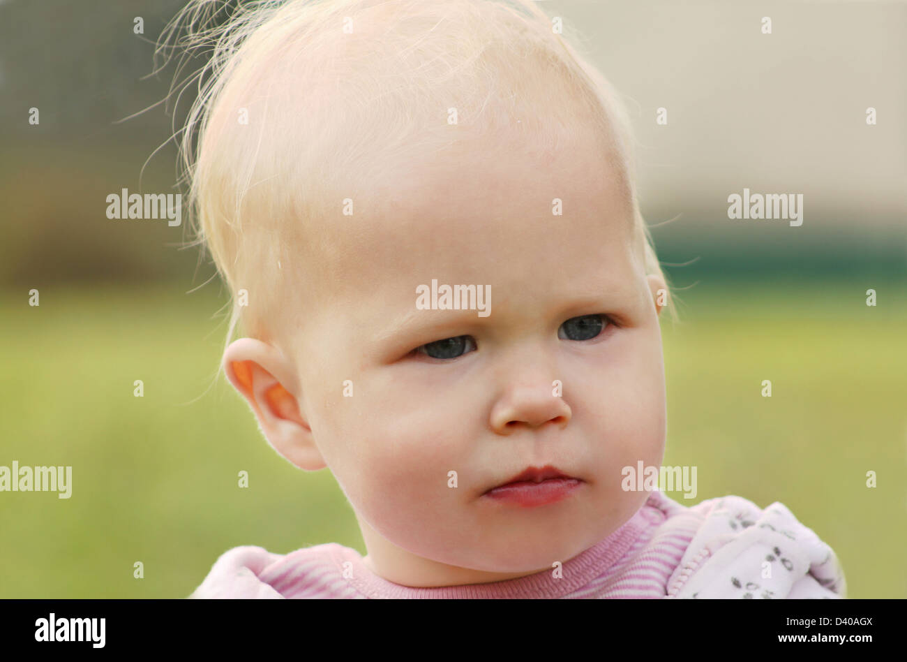 Sad baby in the park Stock Photo - Alamy