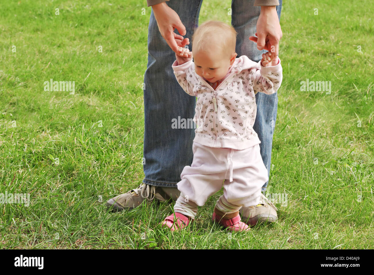 Baby learn walking in the park Stock Photo - Alamy