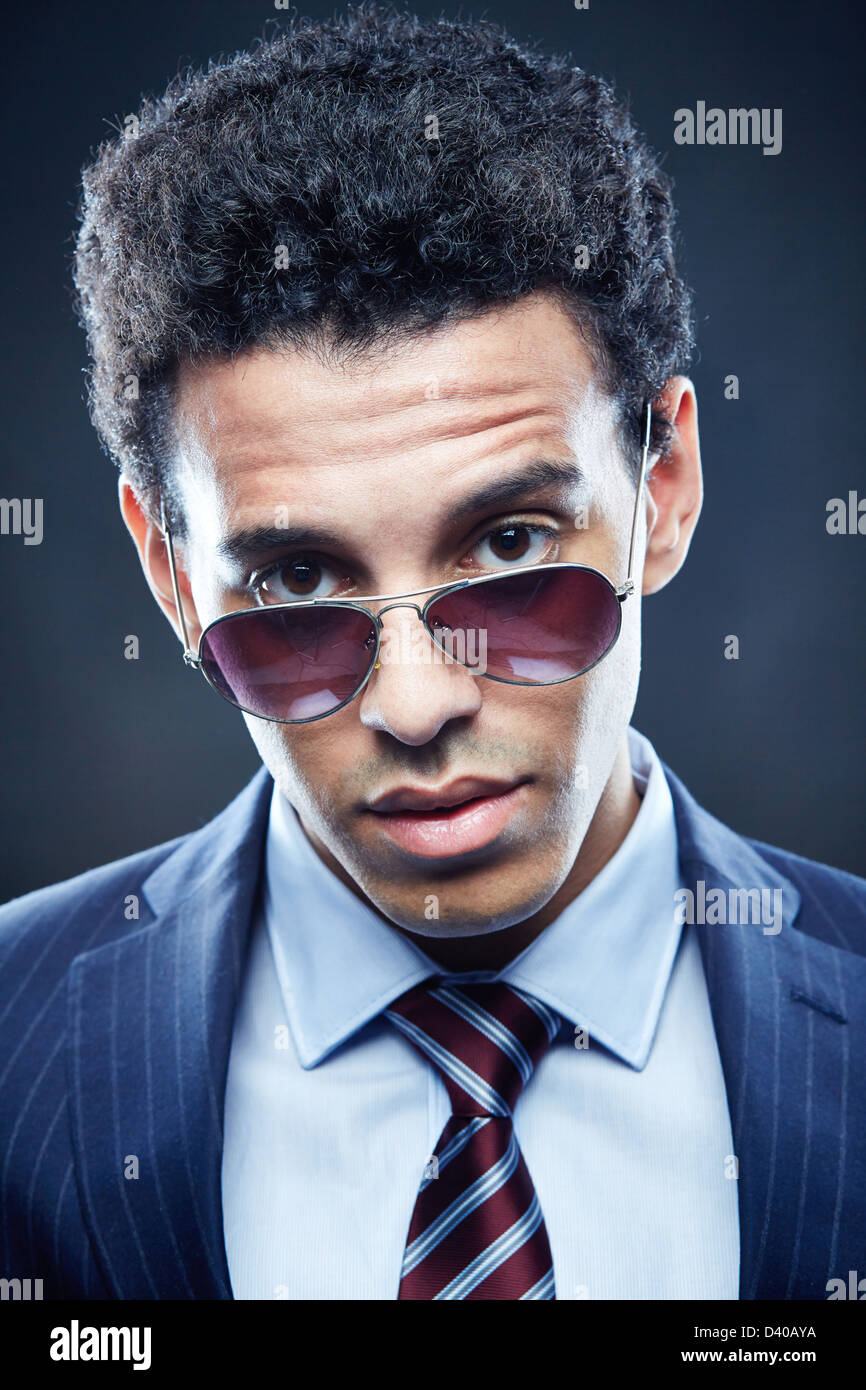 Portrait of calm man in sunglasses looking at camera Stock Photo - Alamy