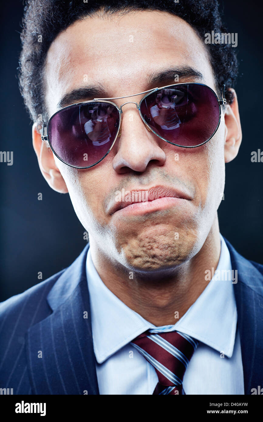 Portrait of doubtful man in sunglasses looking at camera Stock Photo ...