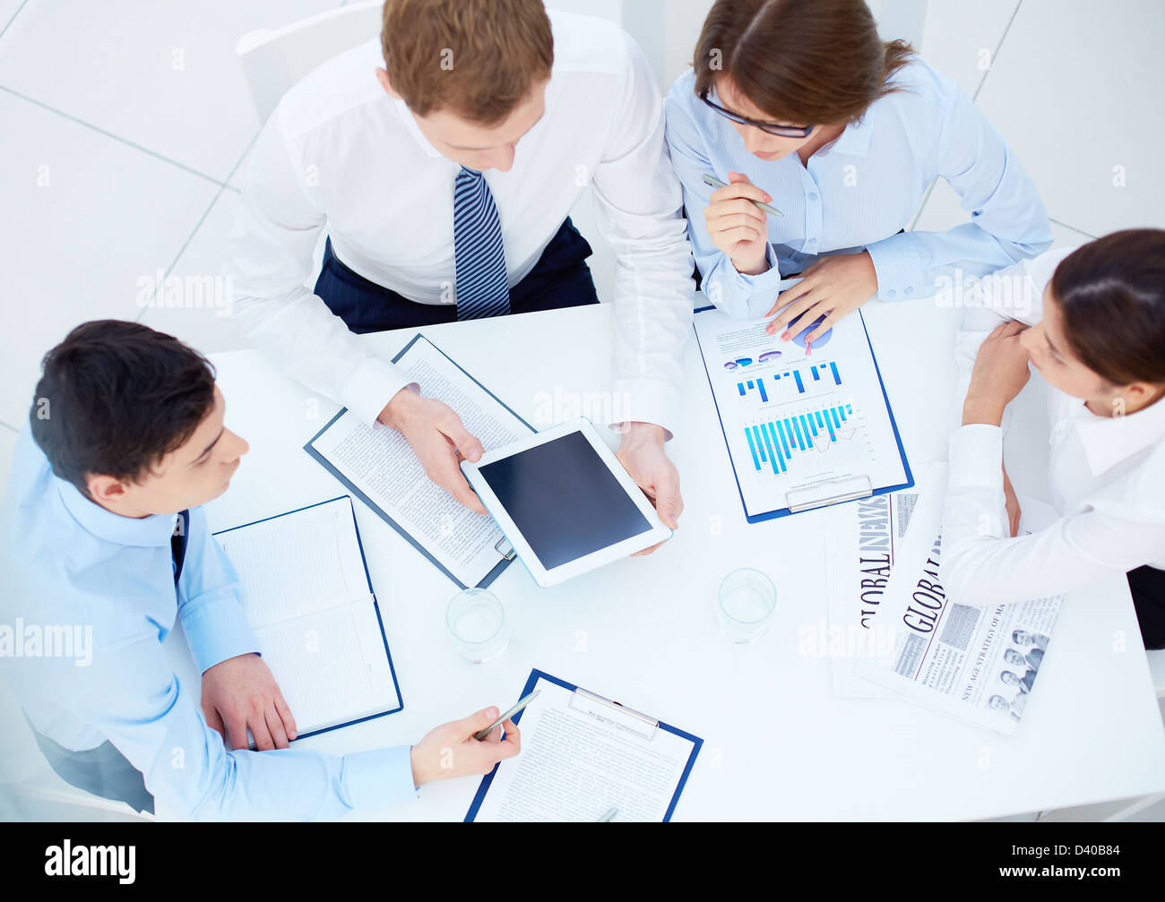 Group of business partners interacting while planning work at meeting ...