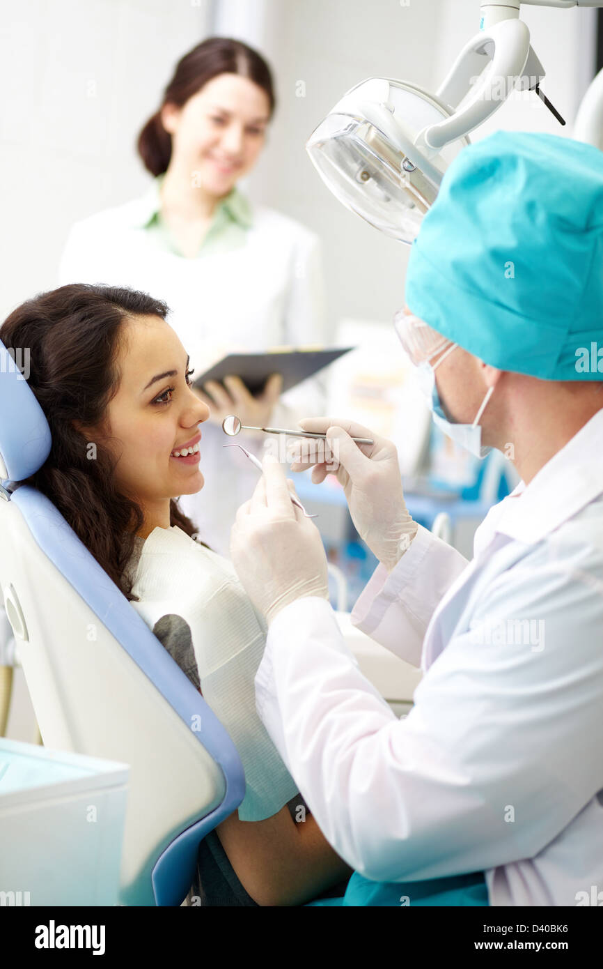 Young female patient receiving dental care from a dentist Stock Photo ...