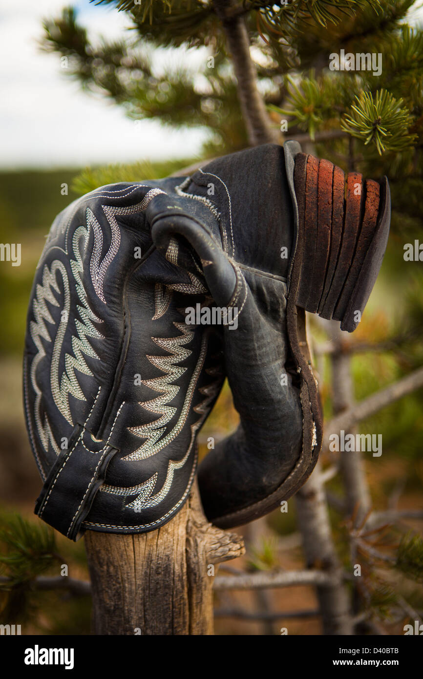 Old, weathered cowboy boot on a wooden post in New Mexico Stock Photo ...