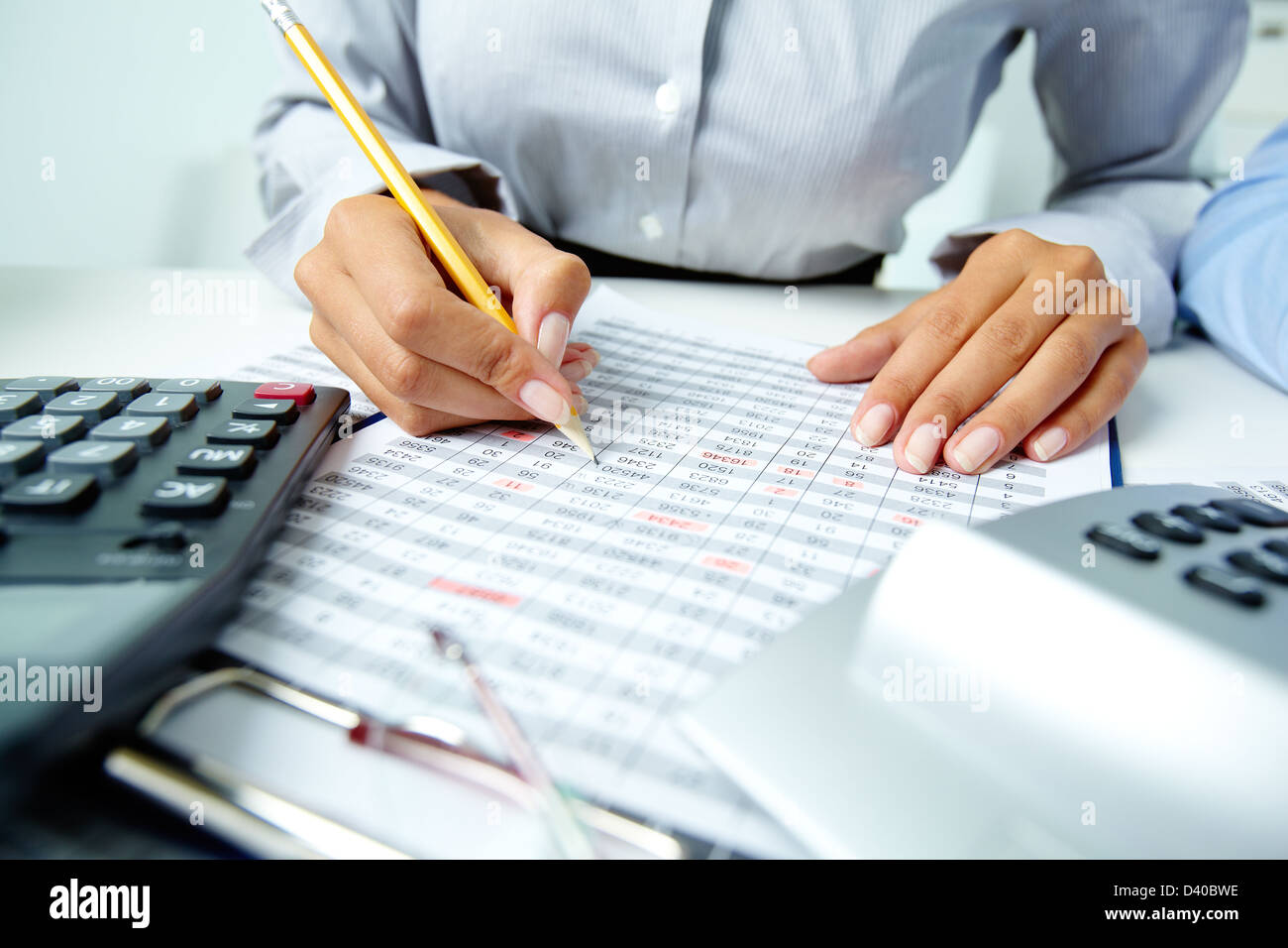 Photo of human hands holding pencil and ticking data in documents Stock ...