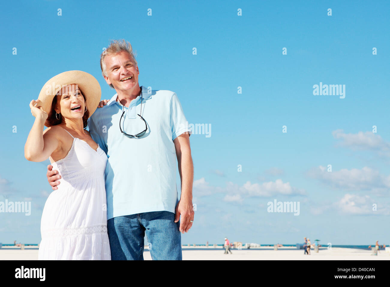 A retiree couple enjoying a summer vacation by the beach Stock Photo ...