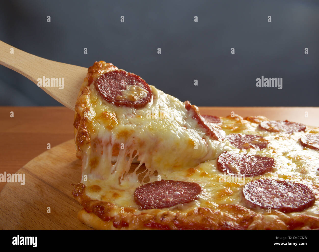 homemade pizza Pepperoni .taking slice of pizza,melted cheese dripping ...