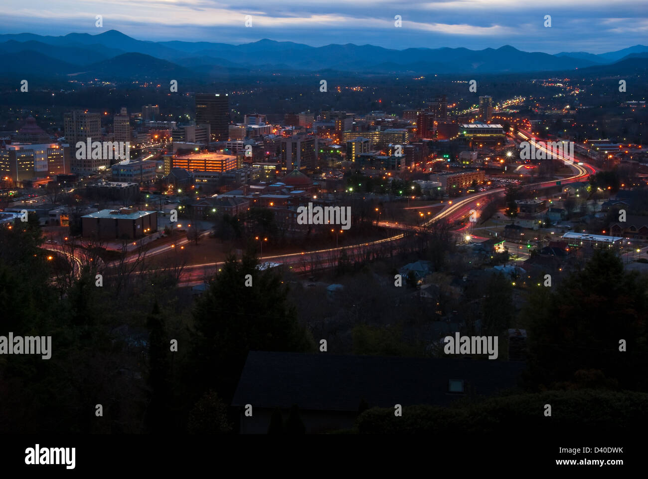 Asheville, North Carolina cityscape and mountain skyline at late dusk ...
